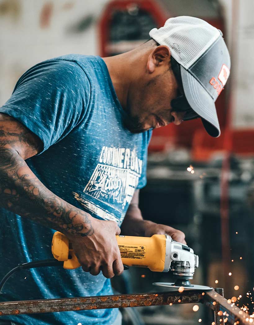 Man Using Angle Grinder – Samsika Marketing Consultants